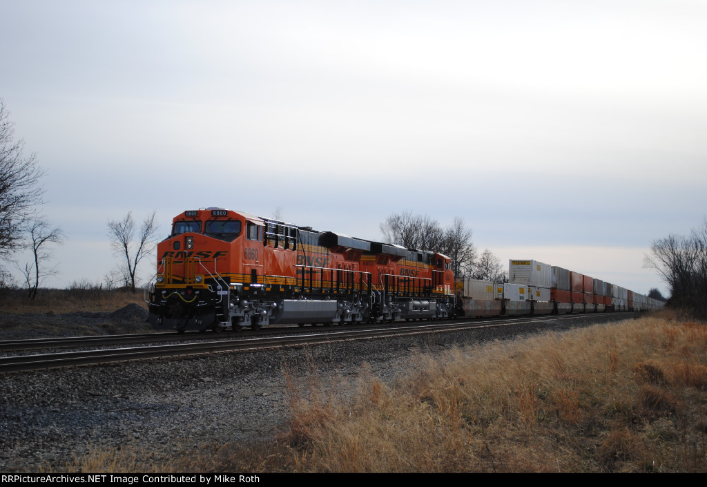 ES44C4 BNSF DPU 6860 pushes west with stacks.